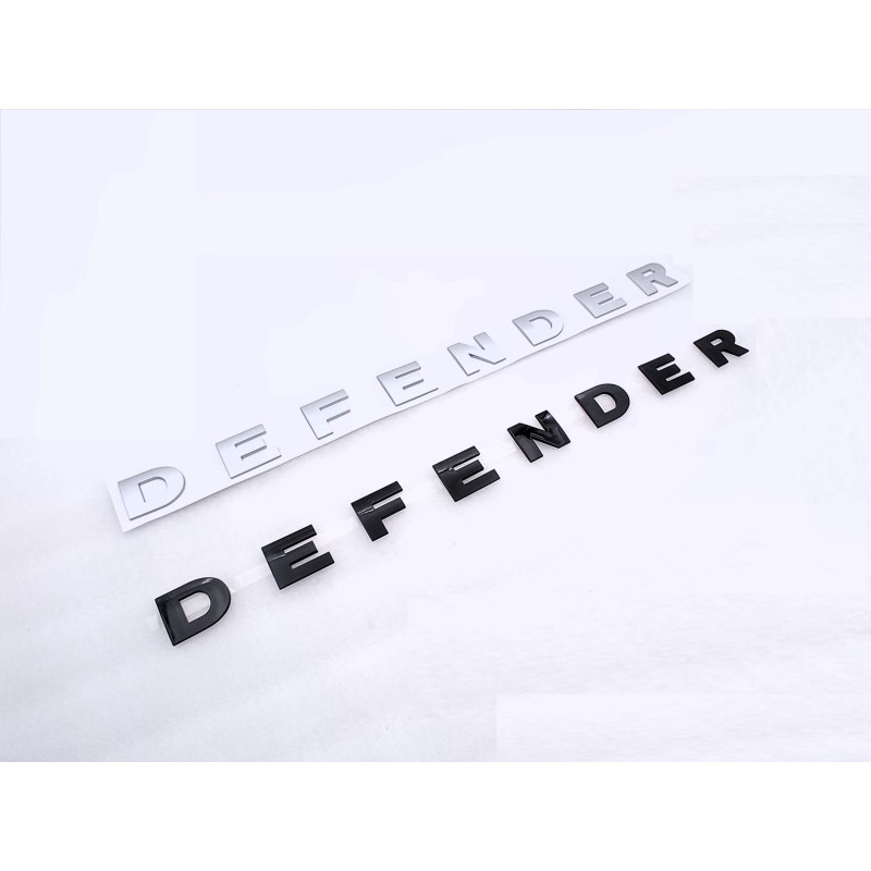 EMBLEMA DELANTERO O TRASERO LETRAS DEFENDER GRIS