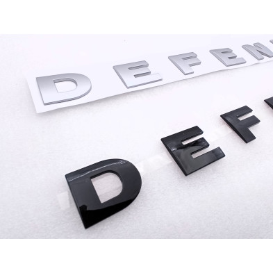 EMBLEMA DELANTERO O TRASERO LETRAS DEFENDER GRIS